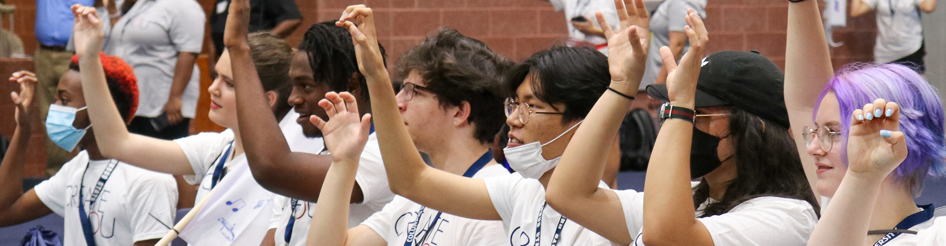 students holding up their hands