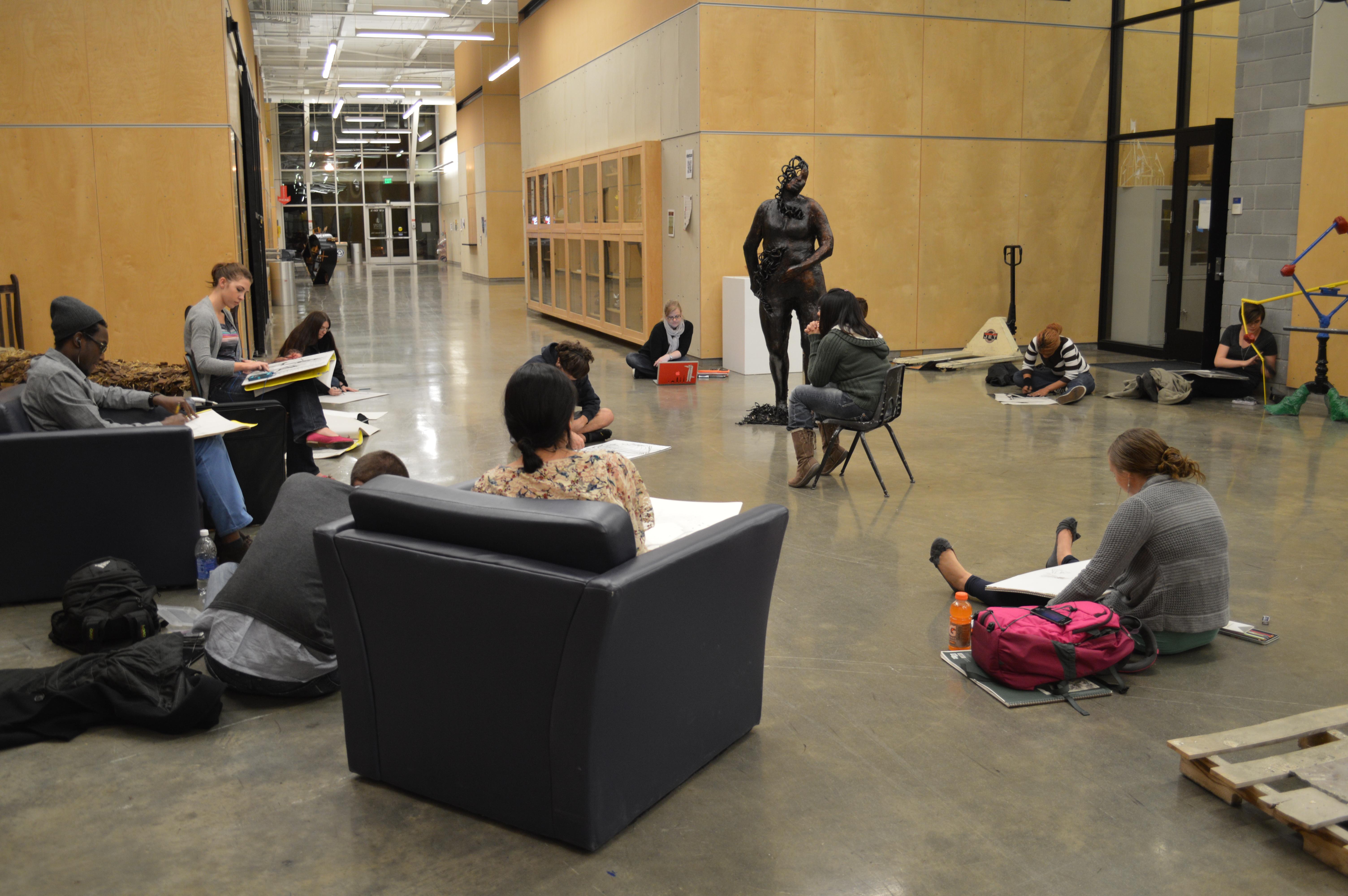 Students relaxing in big black chairs or on the floor