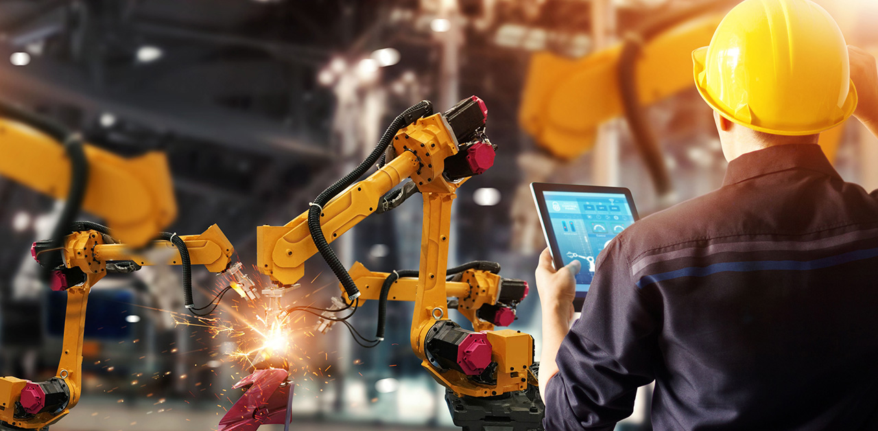 a man looking at robotic arms